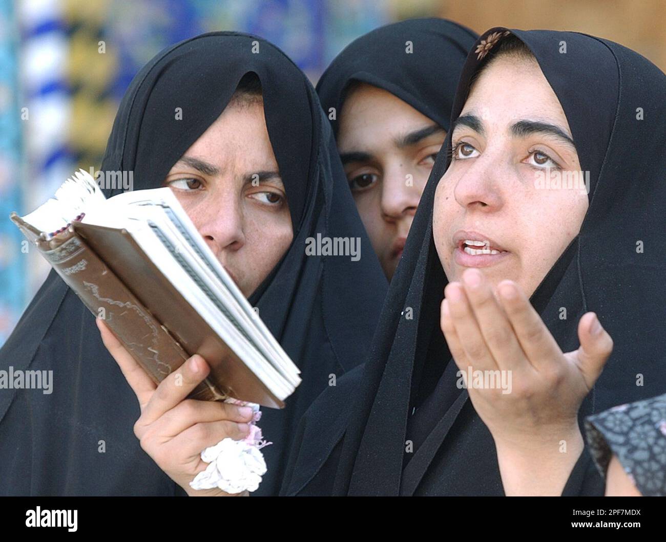 Iraqi women recite prayers on the eve of the Muslim Sabbath on Friday ...