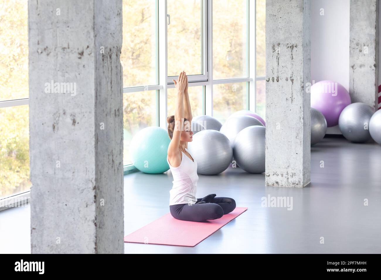 Side view portrait of sporty relaxed woman practicing yoga, doing ...
