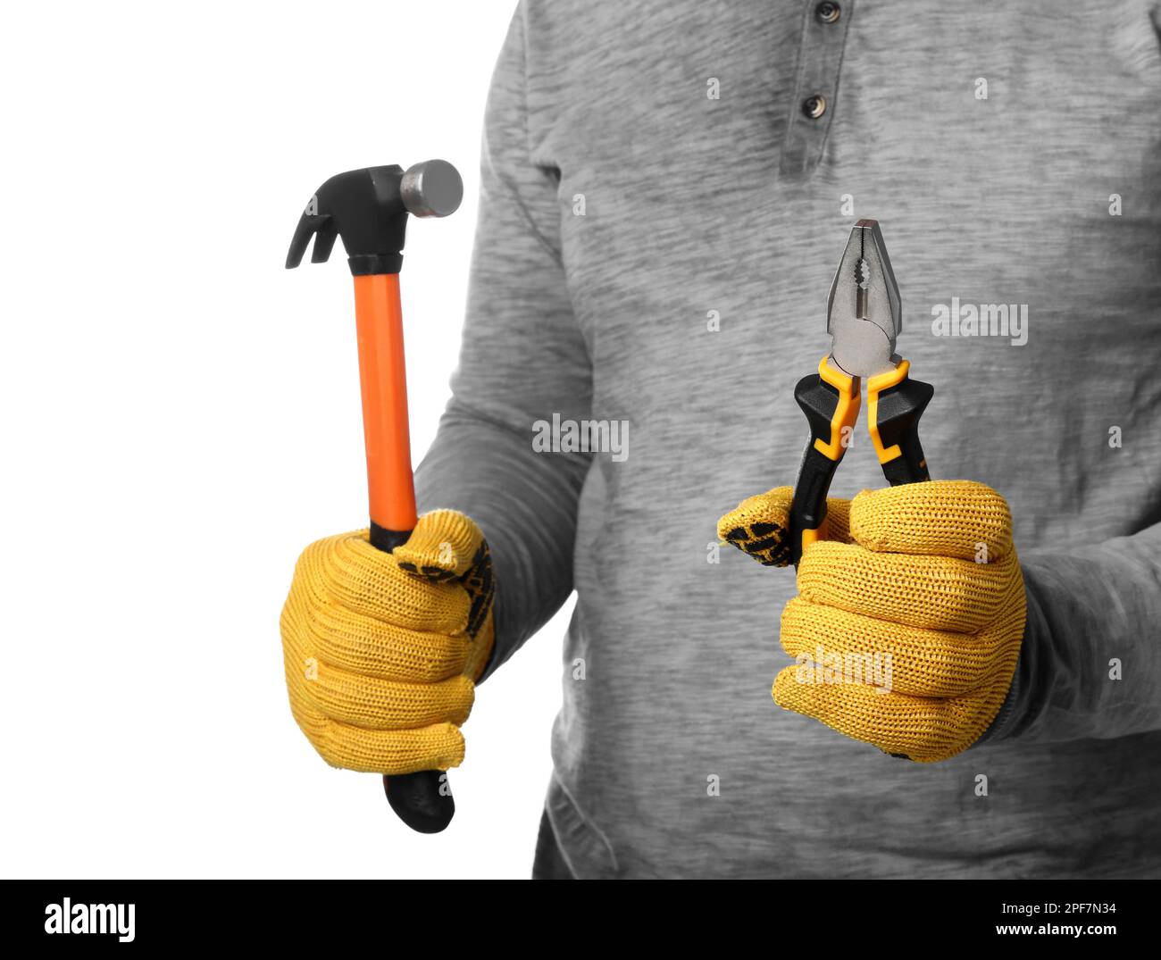 Man in gloves holding pliers and hammer on white background Stock Photo ...