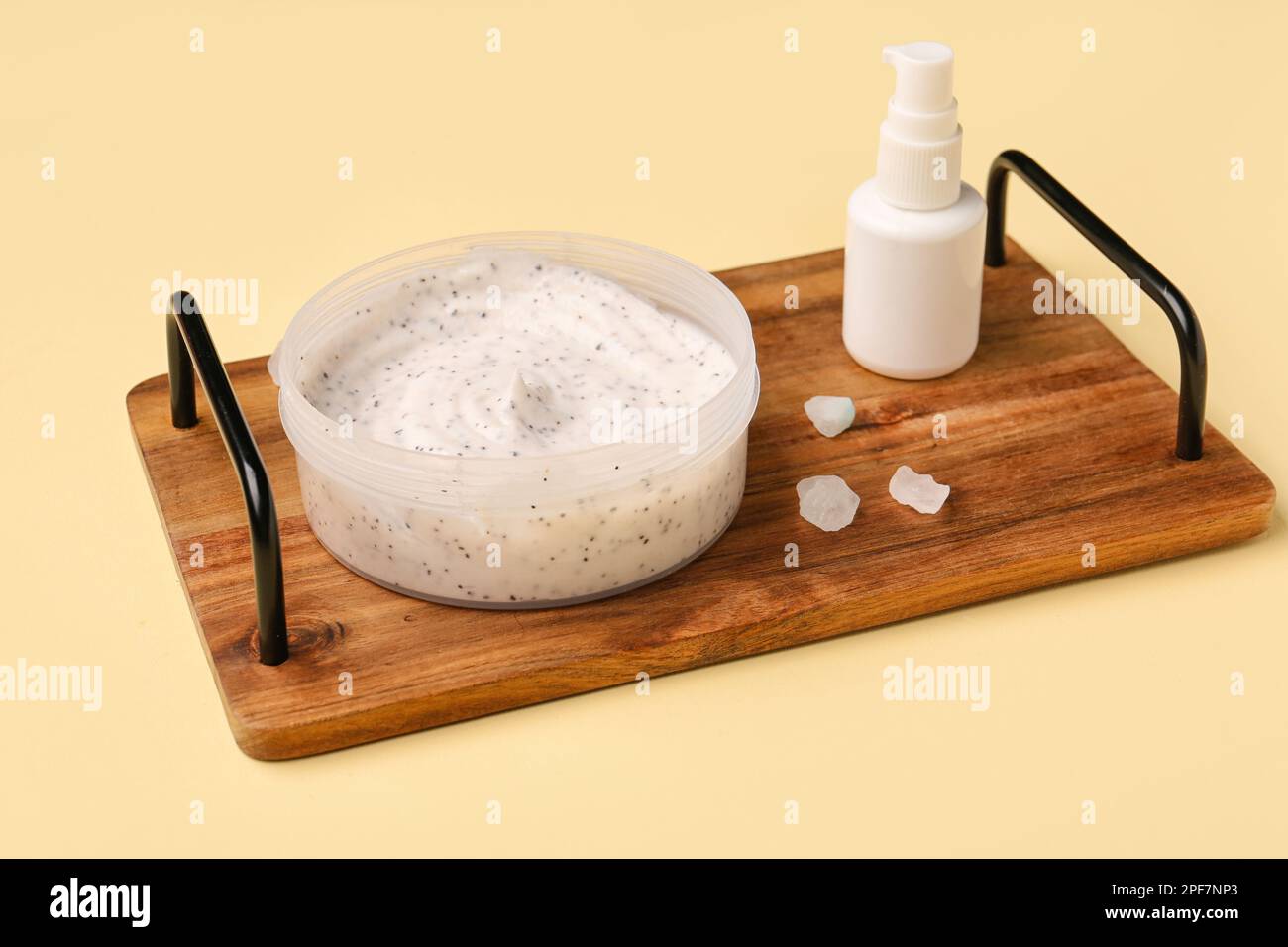 Wooden board with jar of body scrub and cosmetic product on color ...