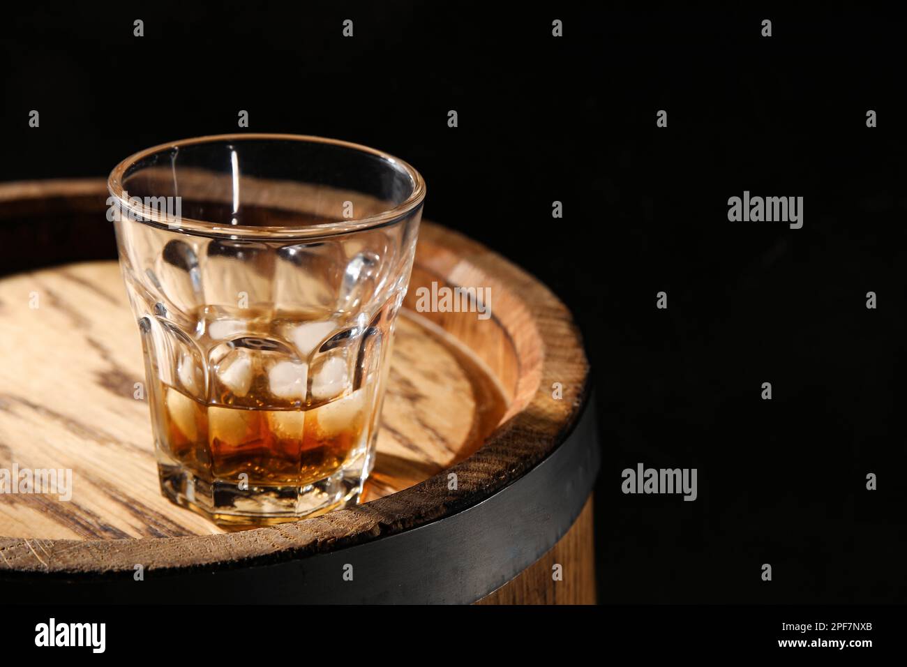 Barrel with glass of cold whiskey on dark background Stock Photo - Alamy