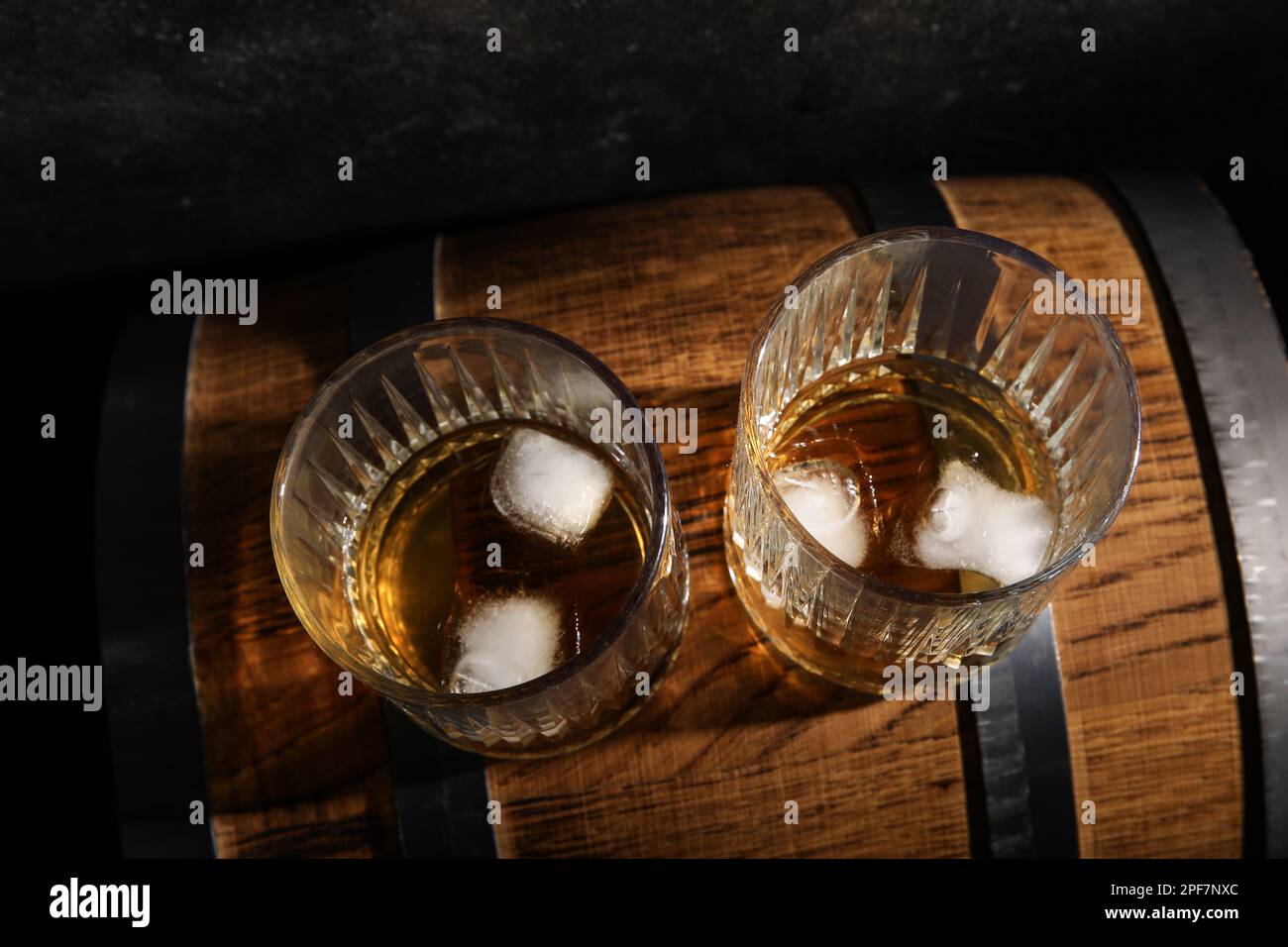 Barrel with glasses of cold whiskey on dark background Stock Photo - Alamy