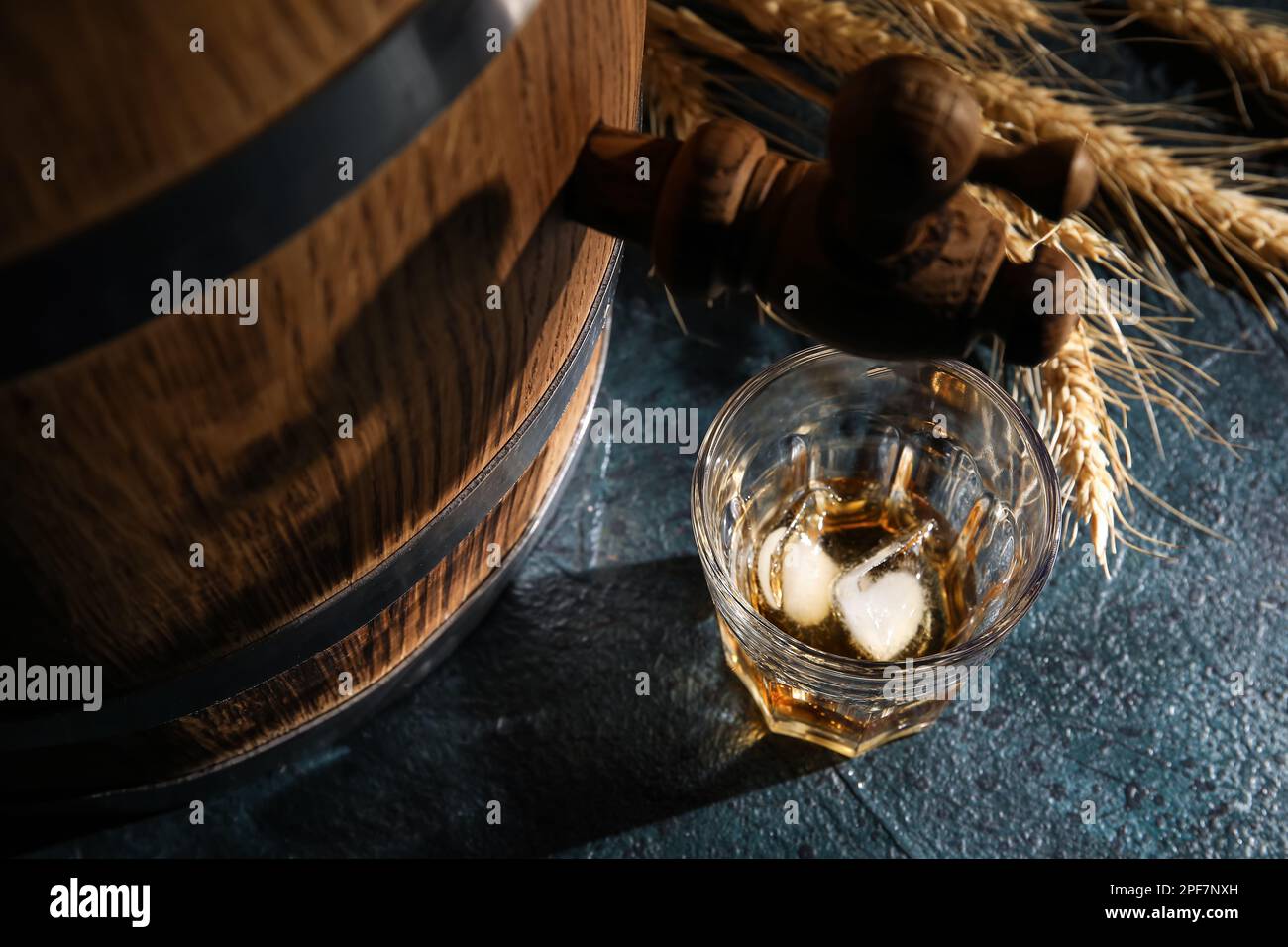 Barrel with glass of cold whiskey on dark background Stock Photo - Alamy