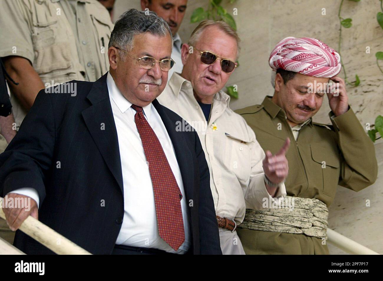Retired US Lt General Jay Garner, center, walks down stairs with ...