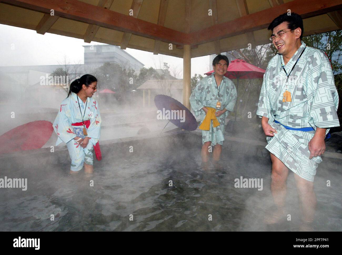 Wearing Japan's summer kimono, called "yukata," Miho Sakiyama, left, Hiroshi Ando, center, and ...
