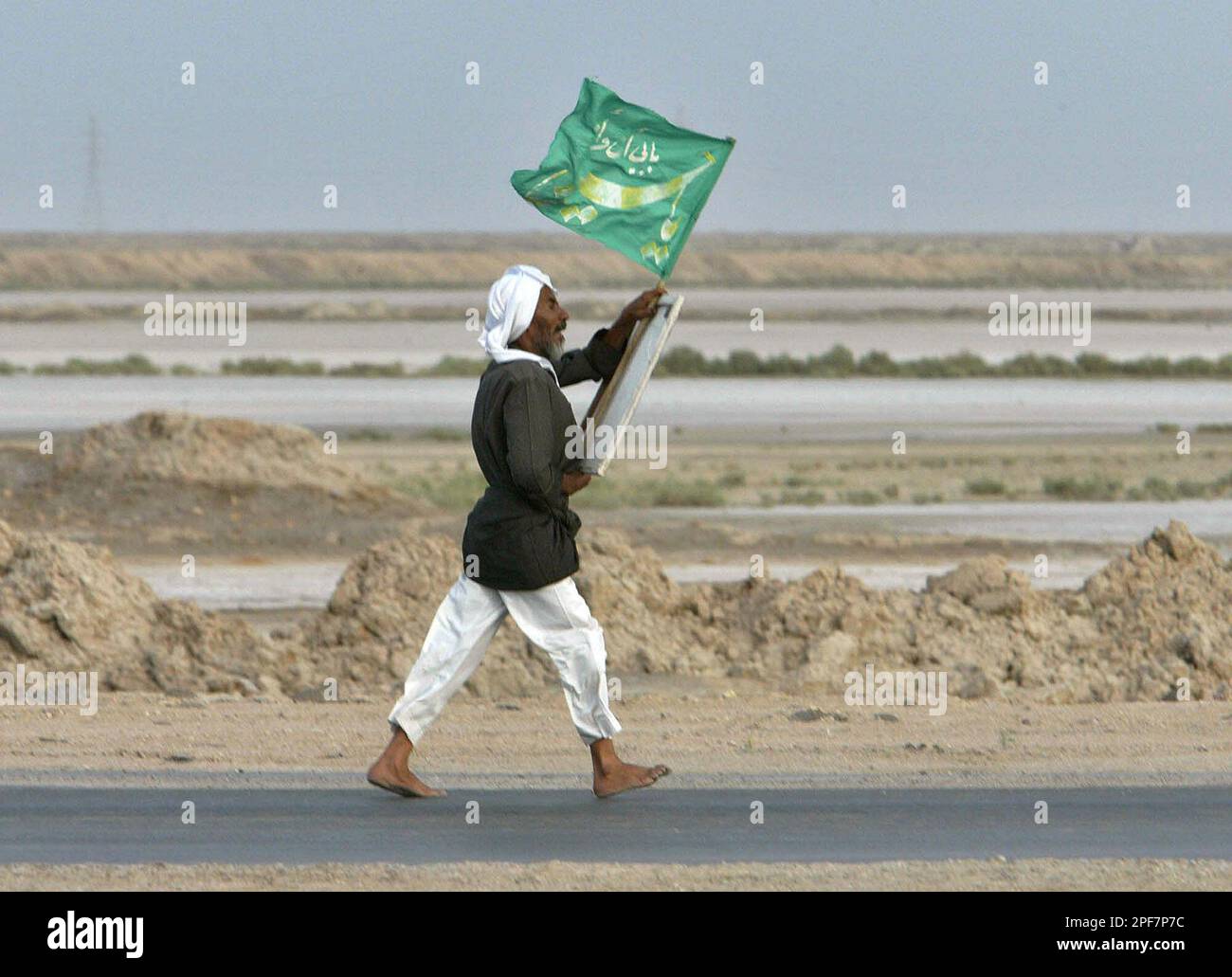 An Iraqi Shiite Muslim walks on the main road linking Basra with the ...