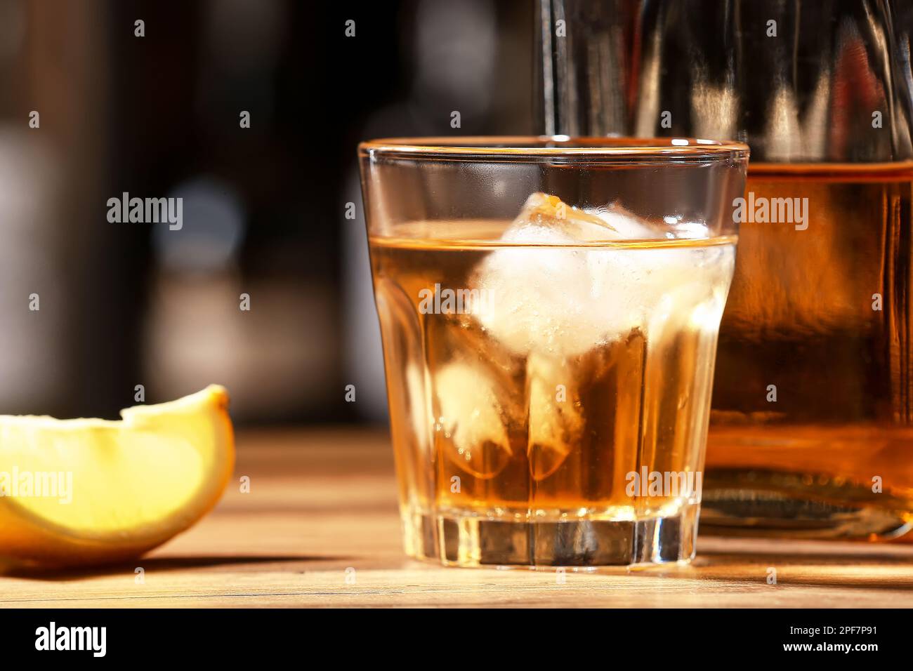 Glass and bottle of tasty rum on table in bar, closeup Stock Photo - Alamy