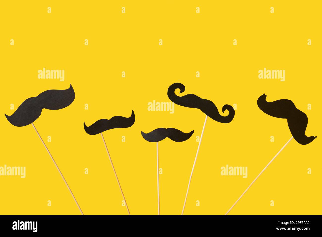Set of different paper mustaches on yellow background Stock Photo - Alamy