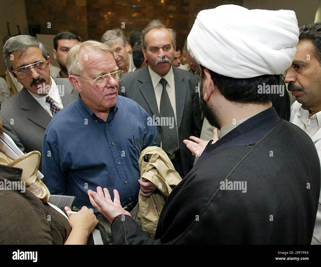 Retired US Lt. General Jay Garner, second from left, is approached by a ...