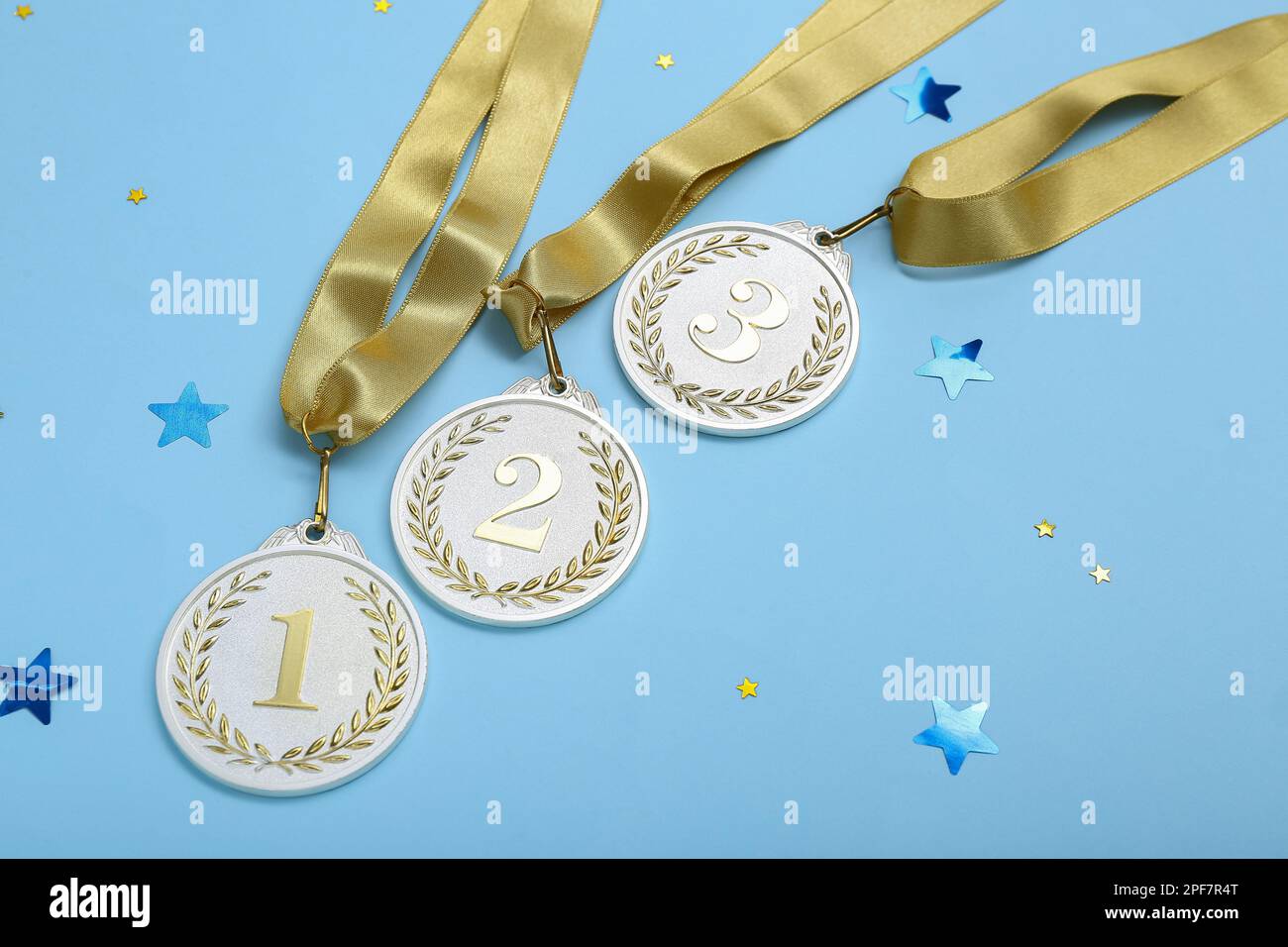 Prize medals with stars on blue background, closeup Stock Photo - Alamy
