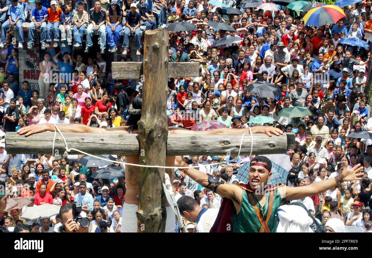 Colombian faithful listen as a "Roman soldier" shouts near a man ...
