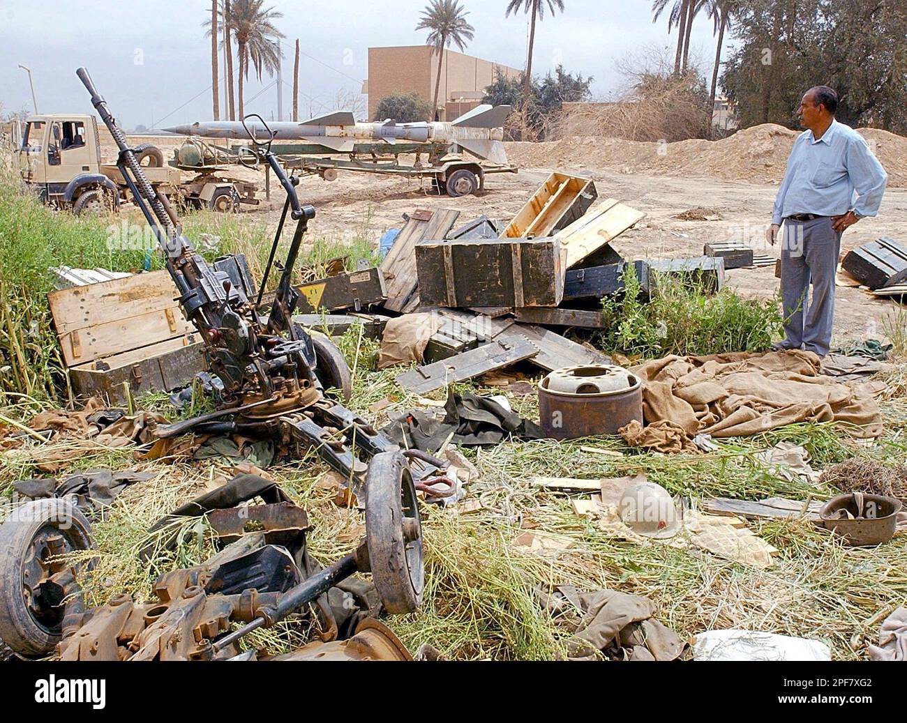 An Iraqi man watches an abandoned SAM surface-to-air missile on its ...