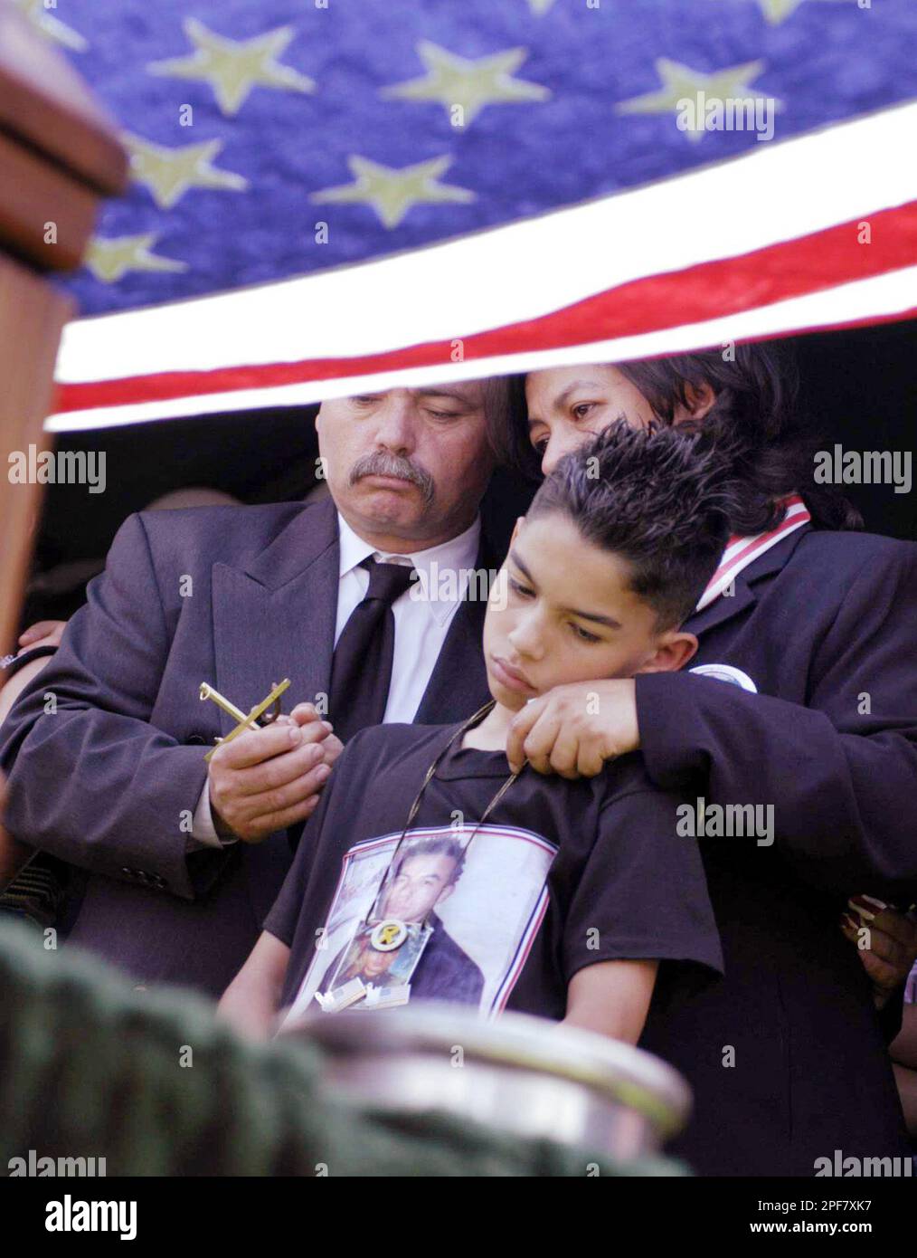 Samuel and Martha Martinez Flores, with their younger son Sammy, grieve ...