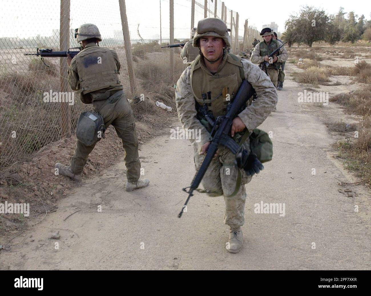 U.S. Marines take positions on the east bank of Tigris river during a ...