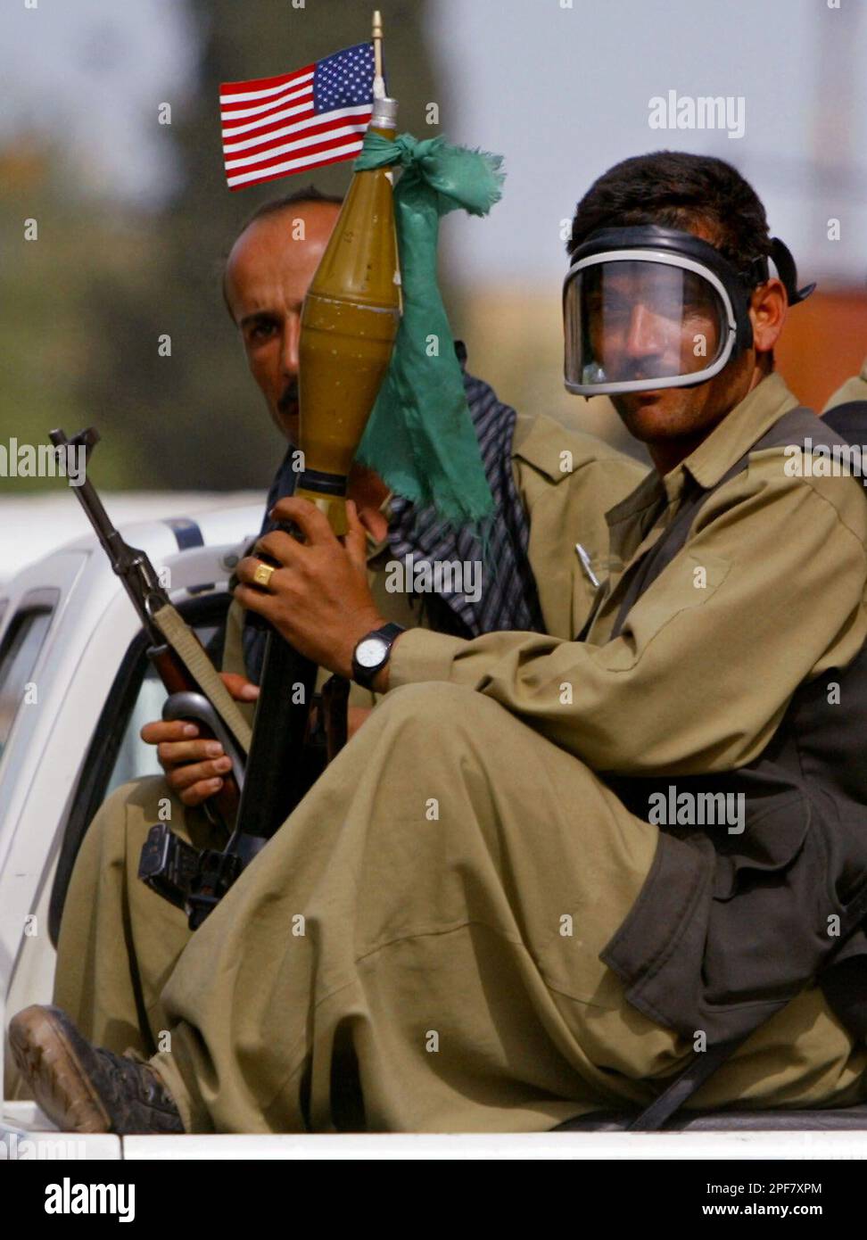 A Kurdish peshmerga fighter loyal to the PUK has a United States flag ...