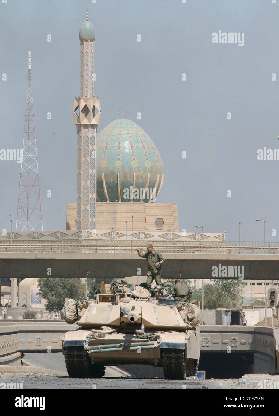 A U.S. tank backdropped by a mosque secures the main highway leading to ...