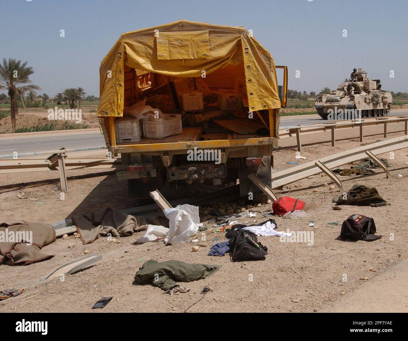 A U.S. (PAC) Personnel Armored Carrier passes an Iraqi military truck ...