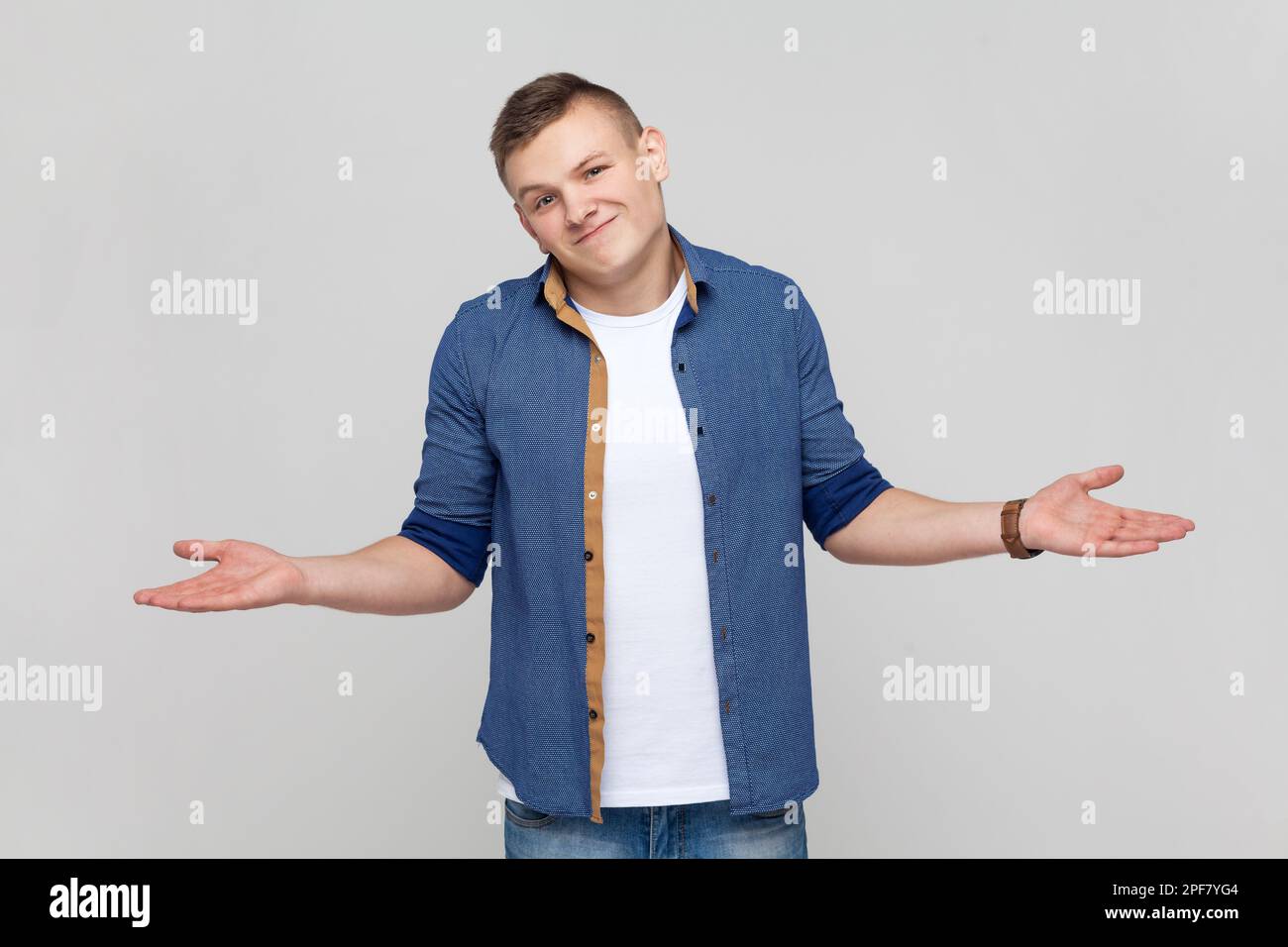 Portrait of open hearted generous teenager boy wearing blue shirt ...