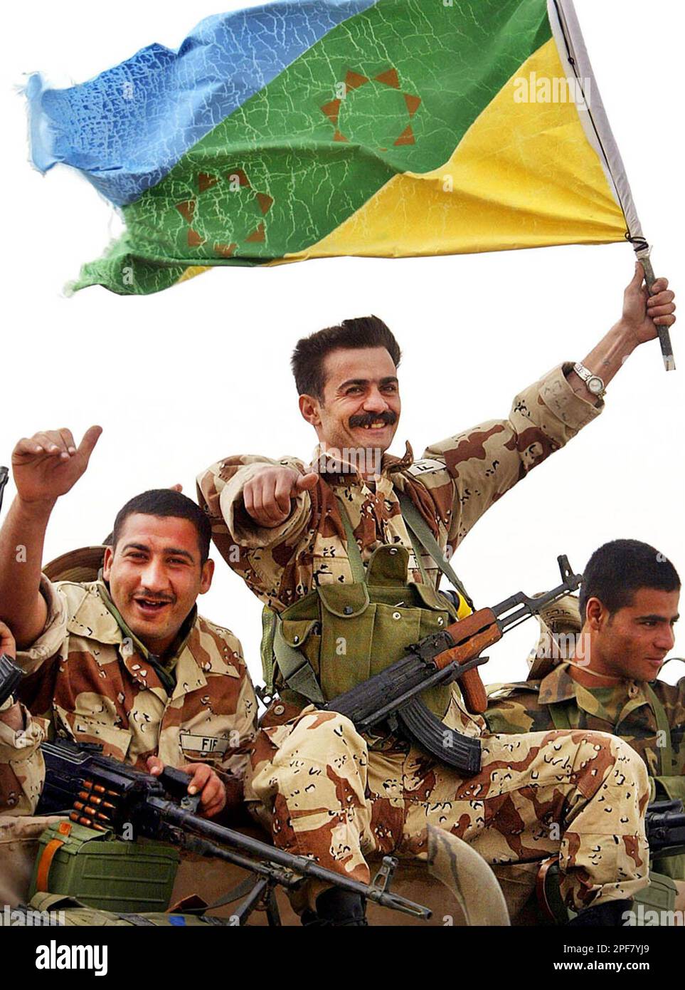 A U.S.-trained Free Iraqi Forces soldier waves their flag from a U.S ...