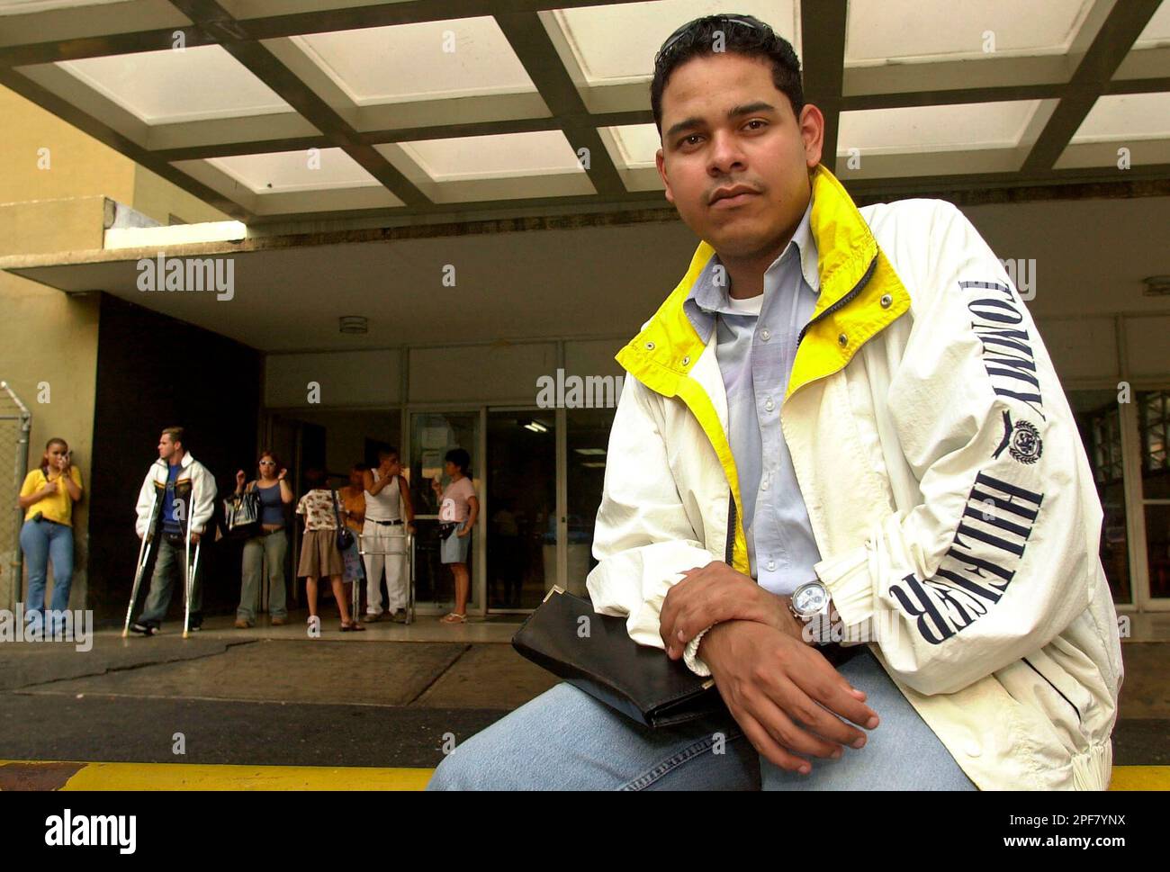 Jean Serrano, 24, poses outside the hospital where he attends physical ...