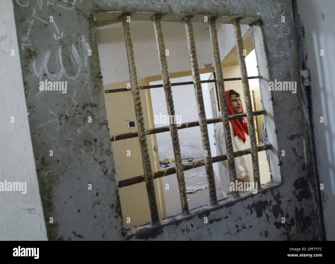 Residents of Basra, Iraq wander through the empty cells of the "White ...
