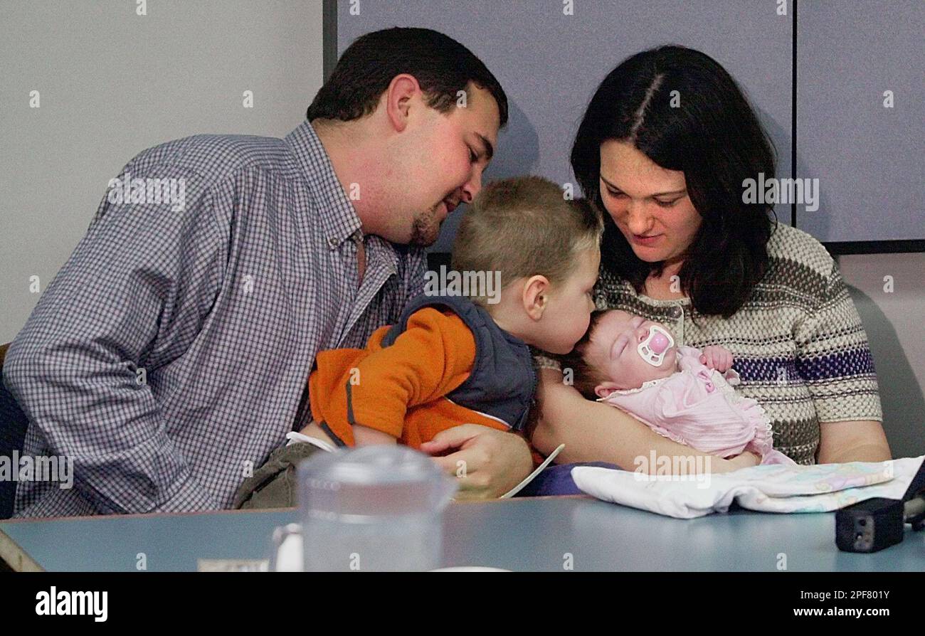 Michael Delveaux, 2, of Oconto Falls, Wis., kisses his 3-month old ...