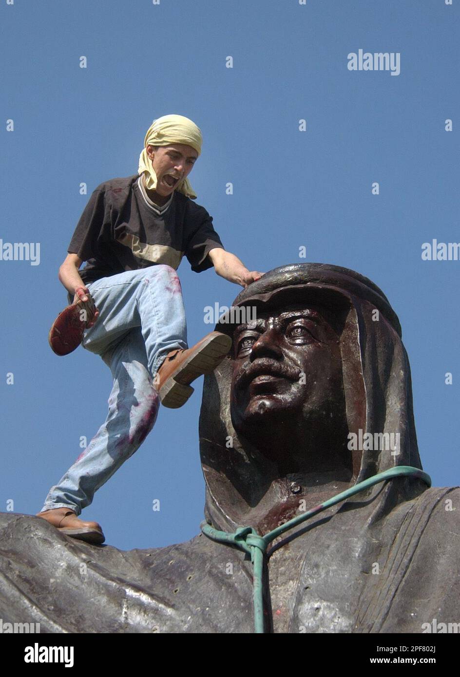 An Iraqi youth wearing a yellow bandana of the Kurdistan Democratic ...