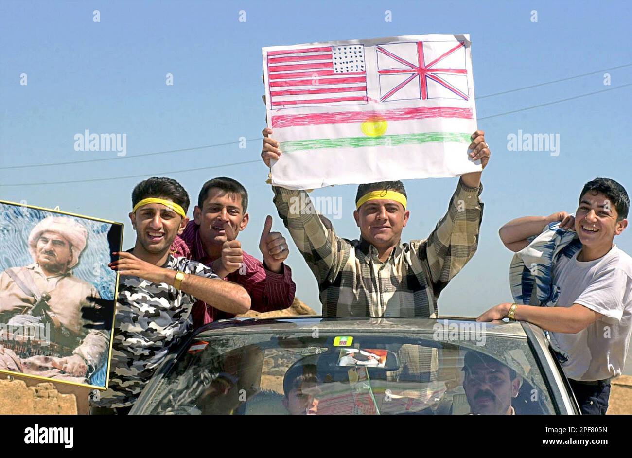 Kurds wearing a yellow headband, a symbol of the flag of the Kurdistan ...