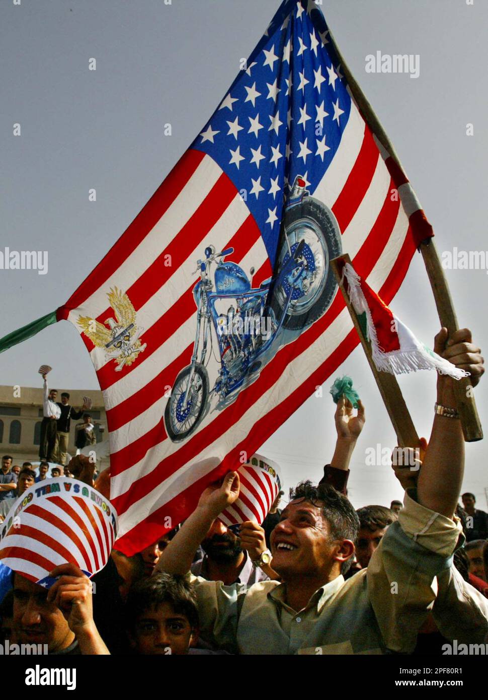 Kurds hold a version of the United States flag during celebrations in ...