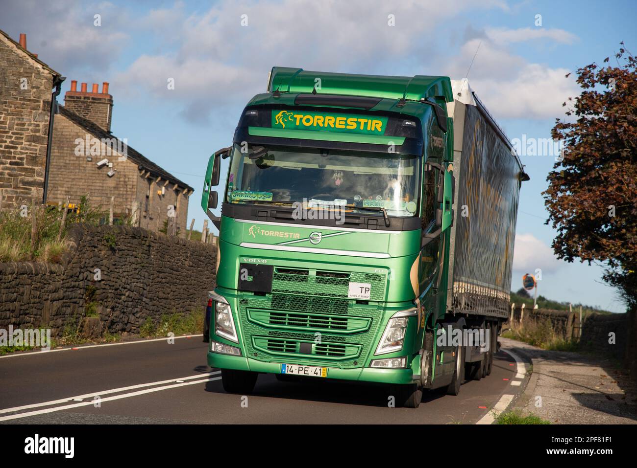 Volvo truck pulling a curtainsider trailer driving on the A628 Woodhead ...