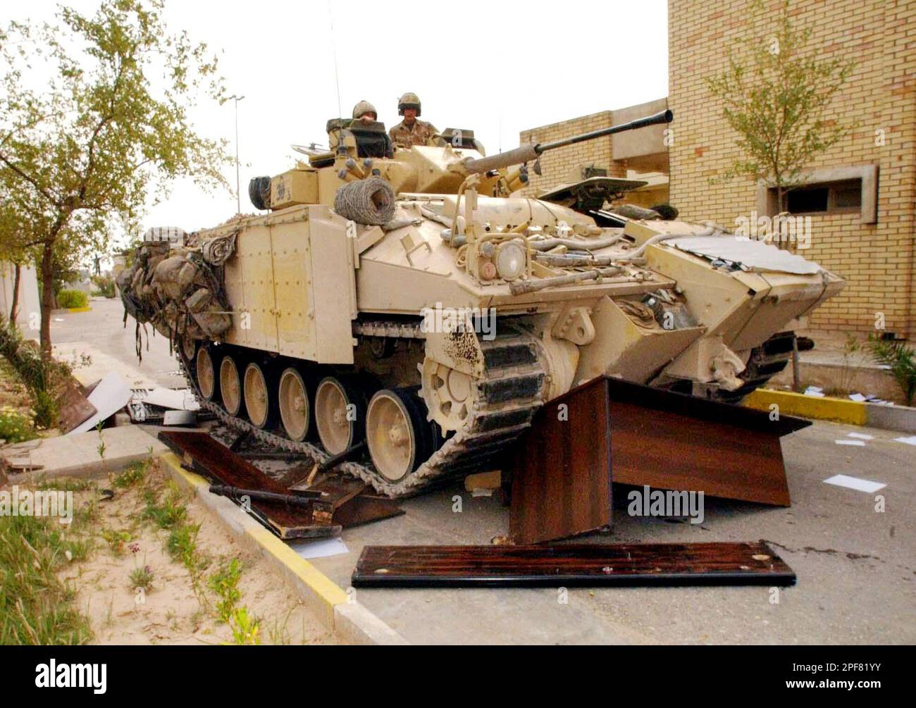 A vehicle from the British 2nd Royal Tank Regiment rolls over furniture ...