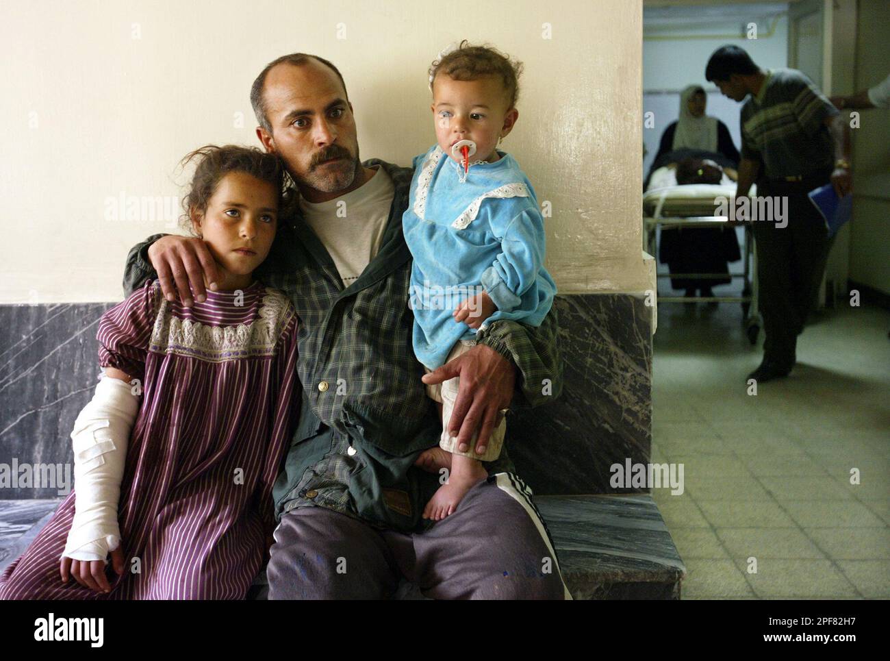 Dahoud Salim holds his nieces Dalhia Nasser, 10, left, and Mihad Ali, 3 ...