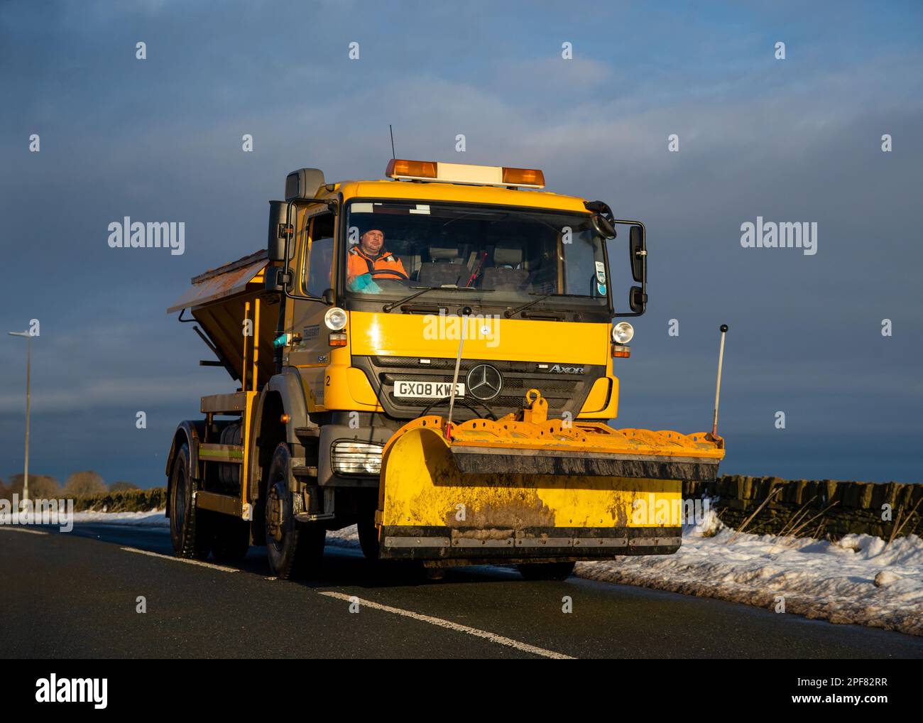 Mercedes Benz Arocs snow plough and gritter truck operating on the ...