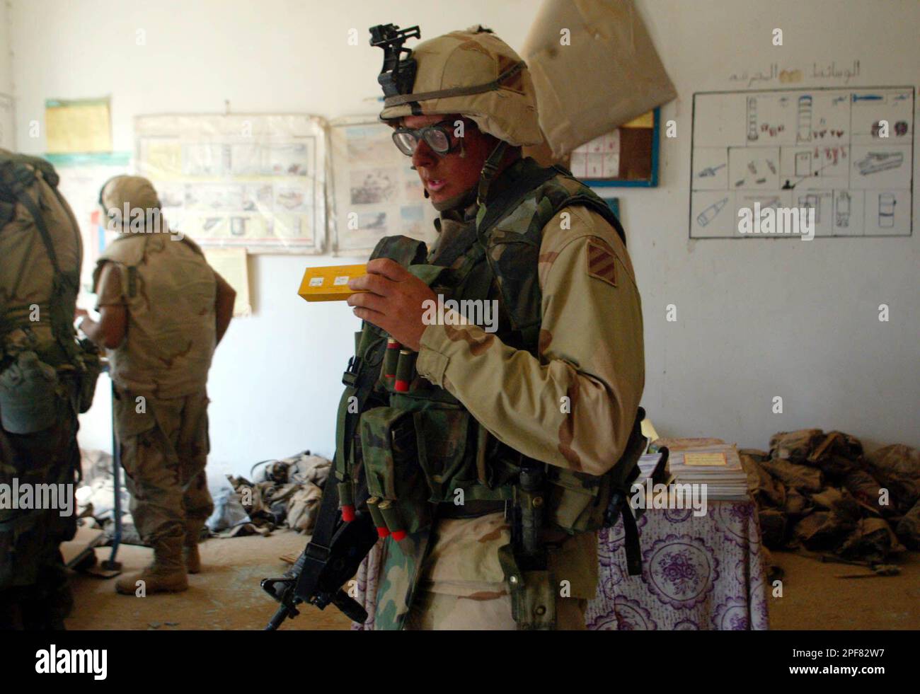 A U.S. Army 1st Lt. Eric Hooper reads the side of a box of atropine, an ...