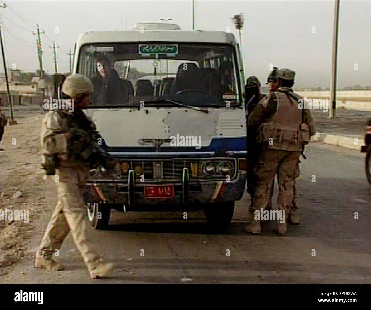 British soldiers, seen in this image from video, stop a vehicle in ...