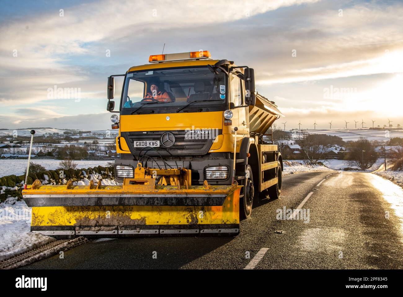 Mercedes Benz Arocs snow plough and gritter truck operating on the ...