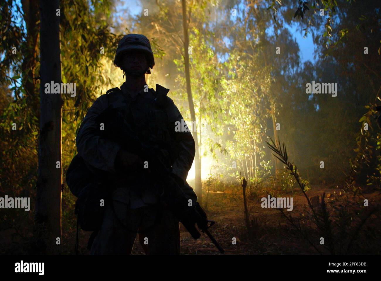 A U.S. Army soldier stands by as a thermite incendiary grenade burns a ...