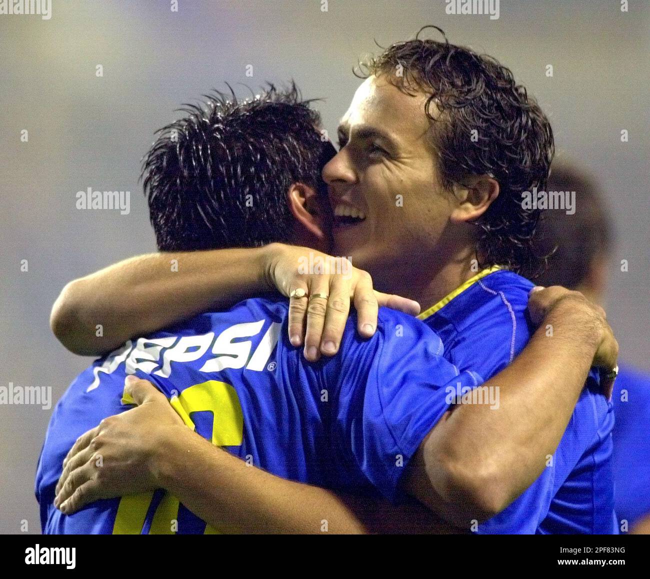 Gustavo Pinto, right, of Boca Juniors, embraces his teammate Marcelo ...