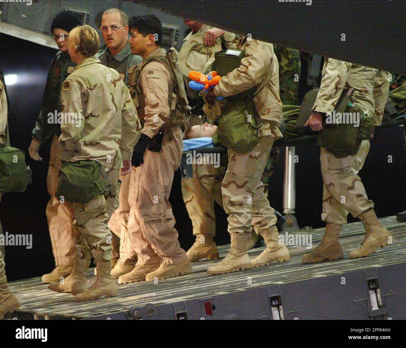 US Army PFC Jessica Lynch is carried on a stretcher off a C-17 military ...