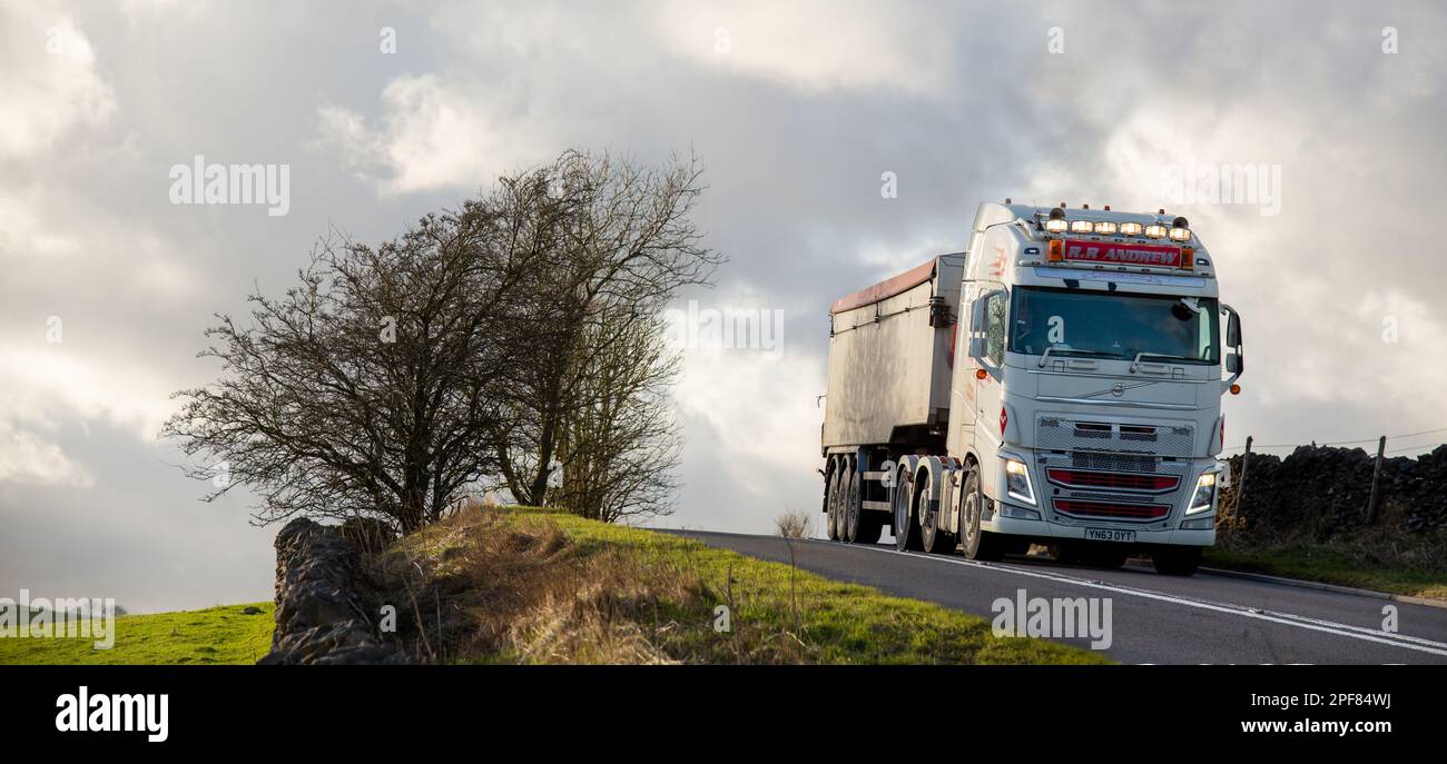 A Volvo bulk tipper on the A623, a rural A-road in the Peak District in ...