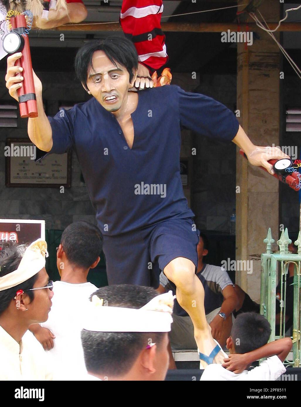 Balinese workers prepare an effigy of Amrozi, one of the Bali bombings ...