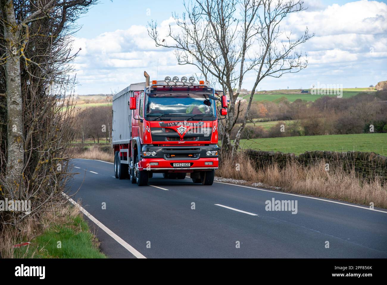 Foden Alpha eight-wheel bulk tipper driving on a country B-road near ...