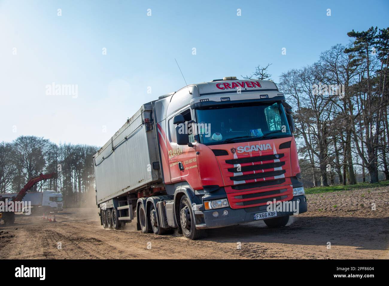 Scania trucks pulling a moving floor bulk tipper trailer being loaded ...