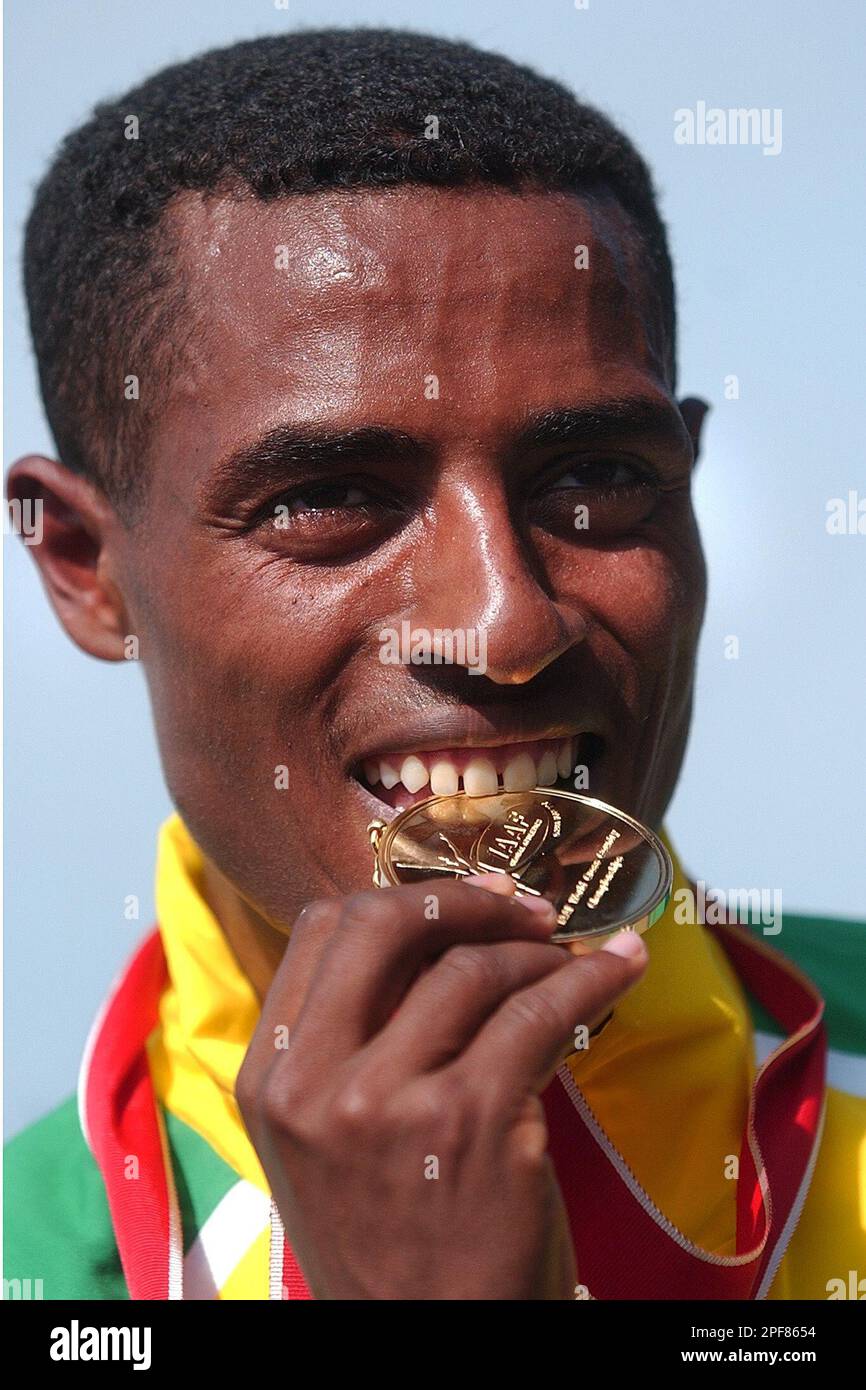Ethiopian Kenenisa Bekele bites his gold medal after winning the men's ...