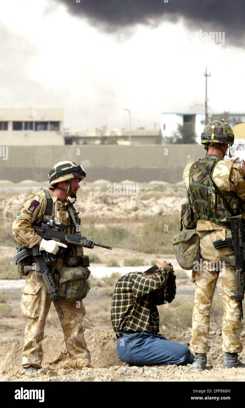 British soldiers arrest an Iraqi man they believe is an Iraqi soldier ...
