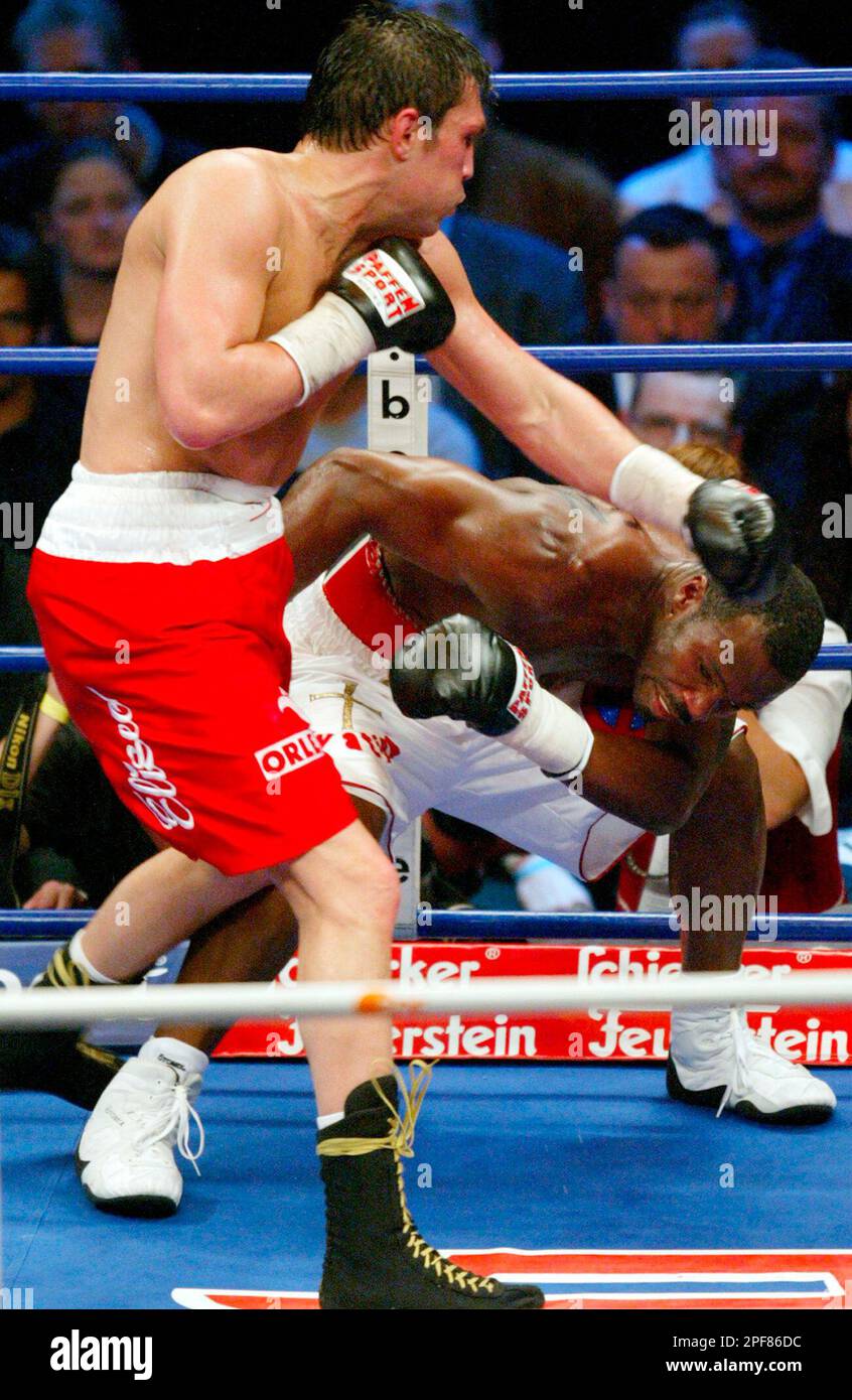Polish boxer Dariusz Michalczewski, left, throws a left to the head of ...