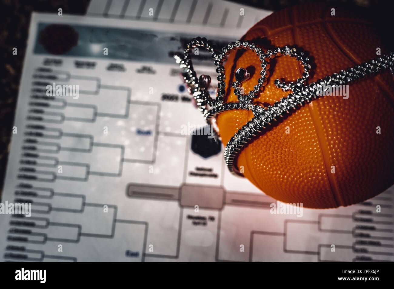 Basketball, tiara, and blank bracket signifying a Cinderella season ...