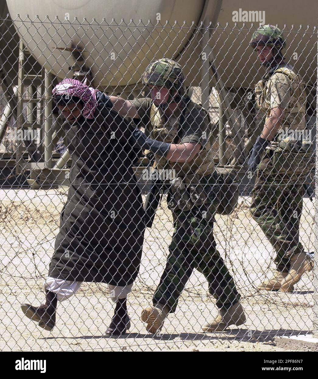 A British soldier from the Light infantry processes an Iraqi prisoner ...