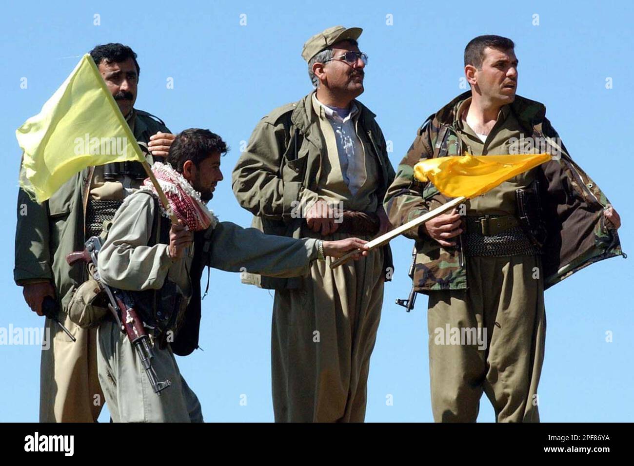 Iraqi Kurdish militiamen wave KDP Kurdistan Democratic Party flags in ...