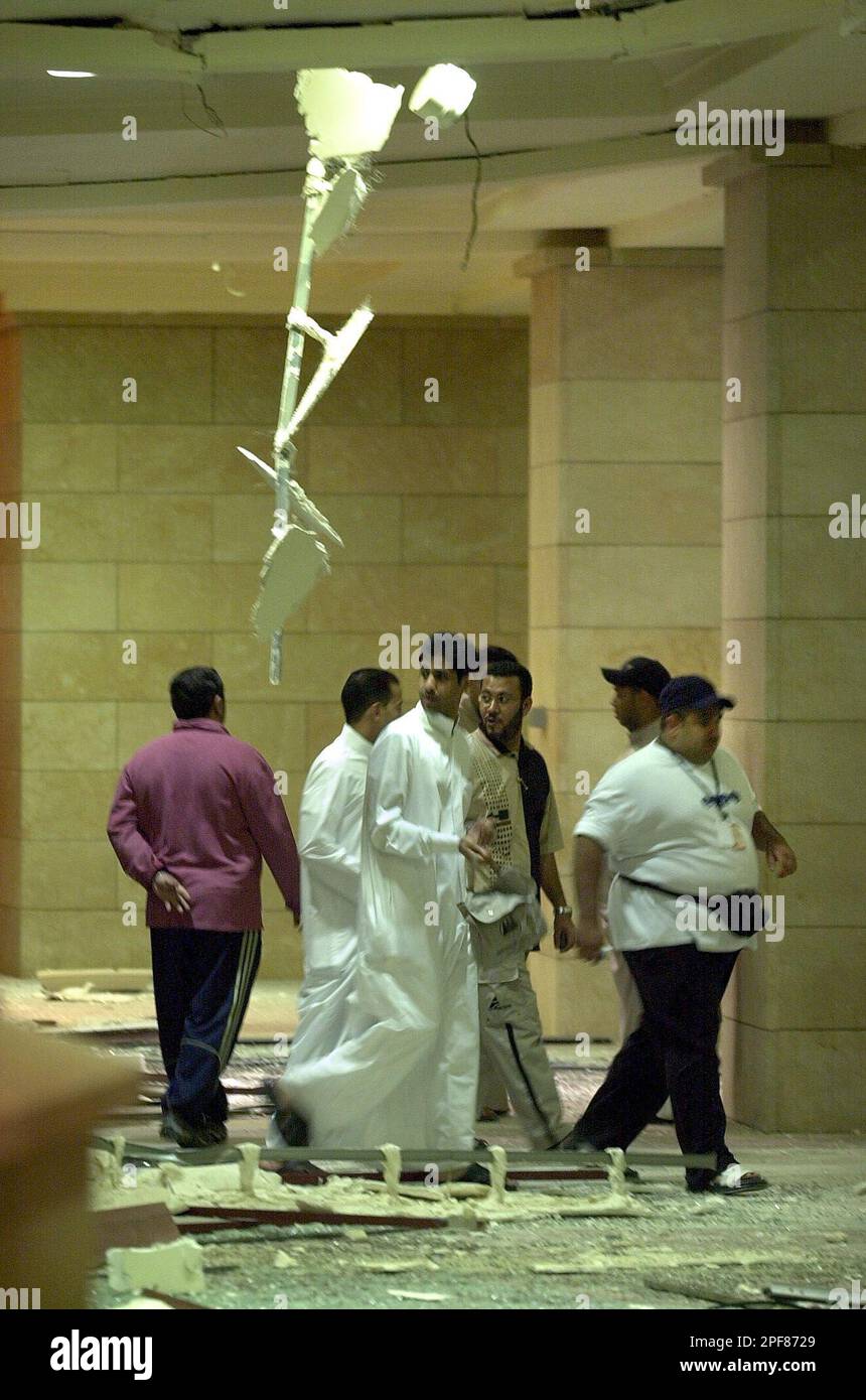 Kuwait soldiers and police inspect the damage caused by the explosion ...